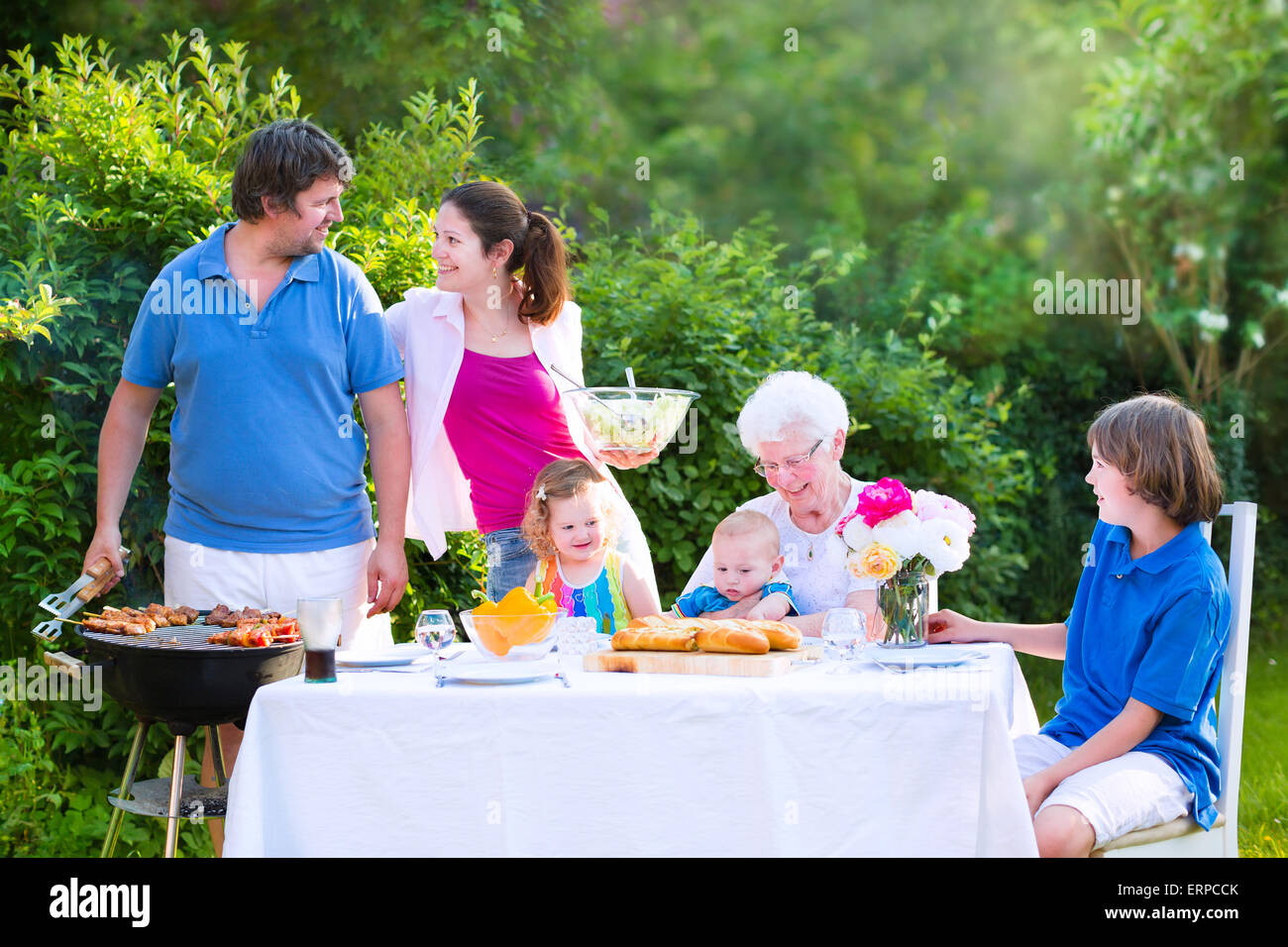 Grill barbecue backyard party. Happy big family enjoying BBQ lunch with ...