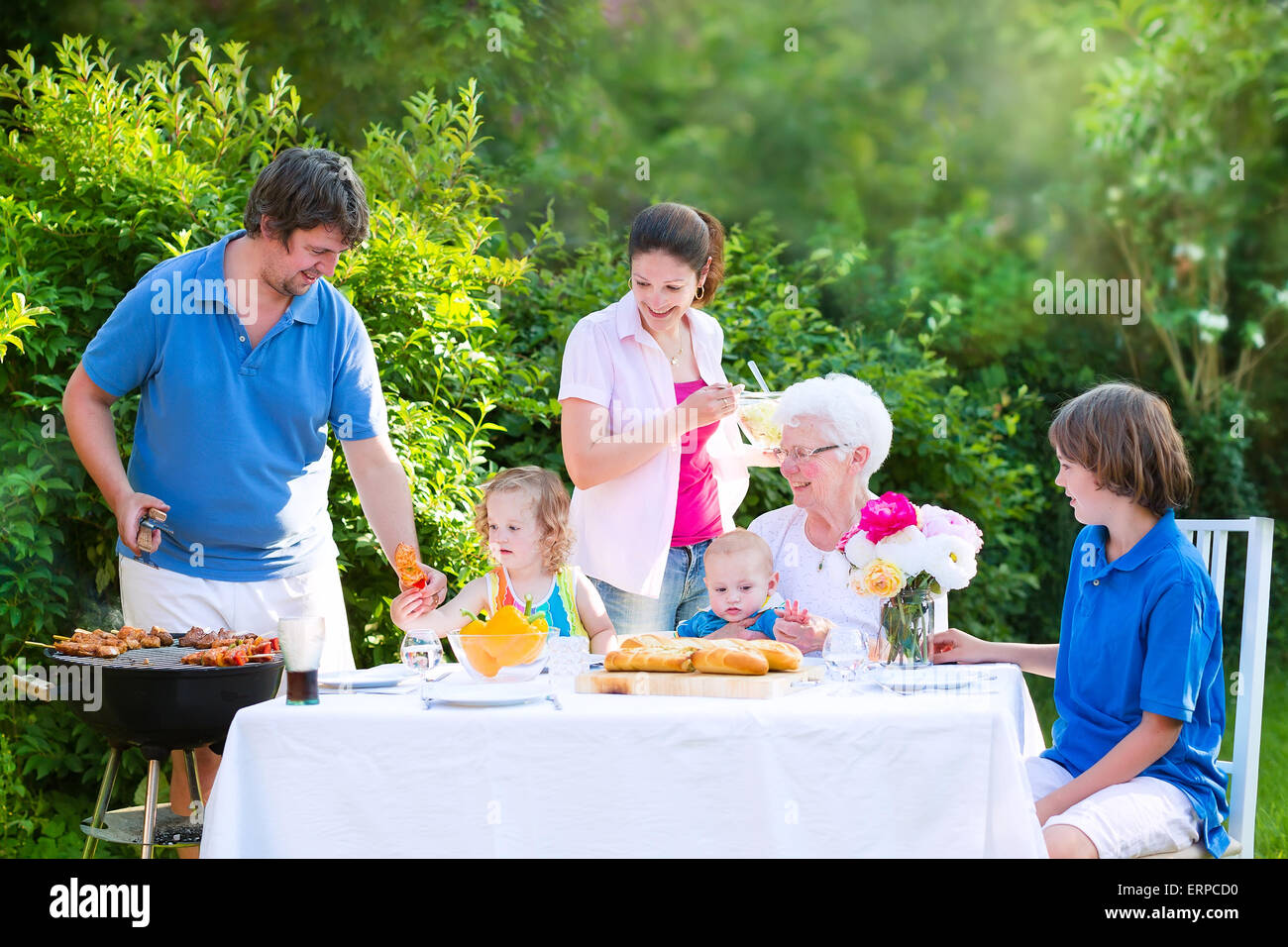 Grill barbecue backyard party. Happy big family enjoying BBQ lunch with ...
