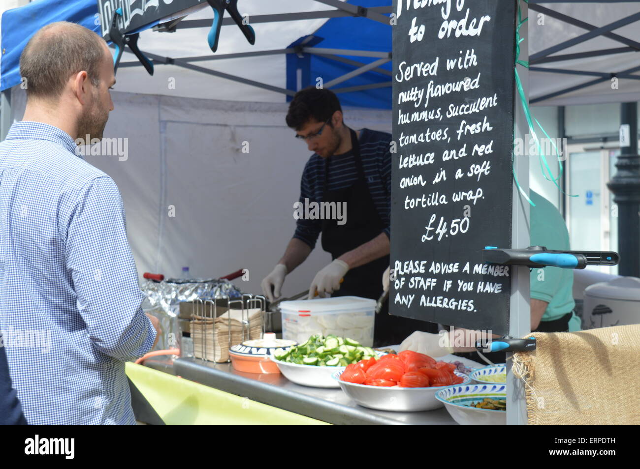 stall holder preparing fresh food for customer at a street market ...
