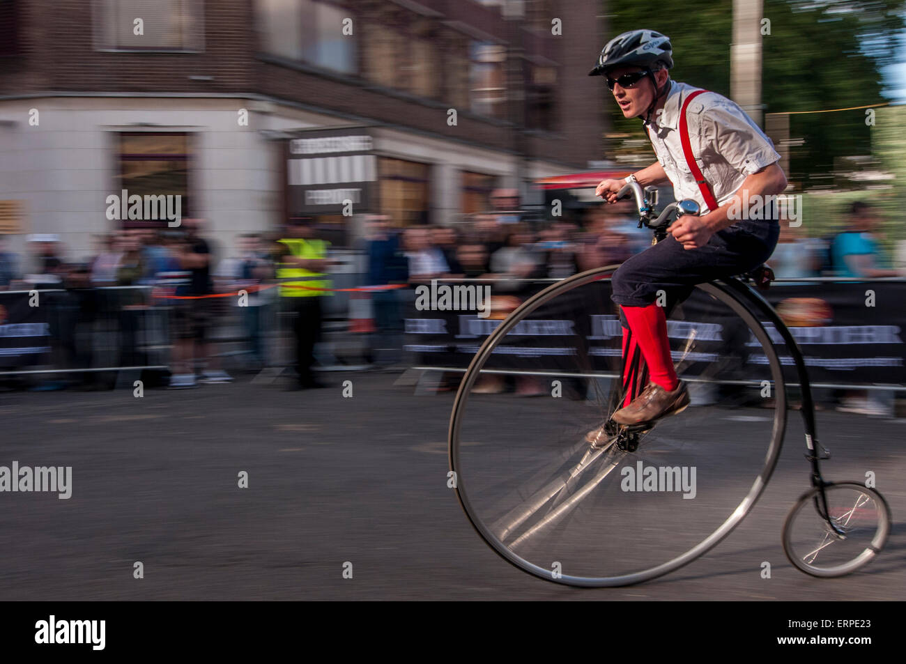 London, UK. 6 June 2015. A man rides by in the Penny Farthing race, as ...