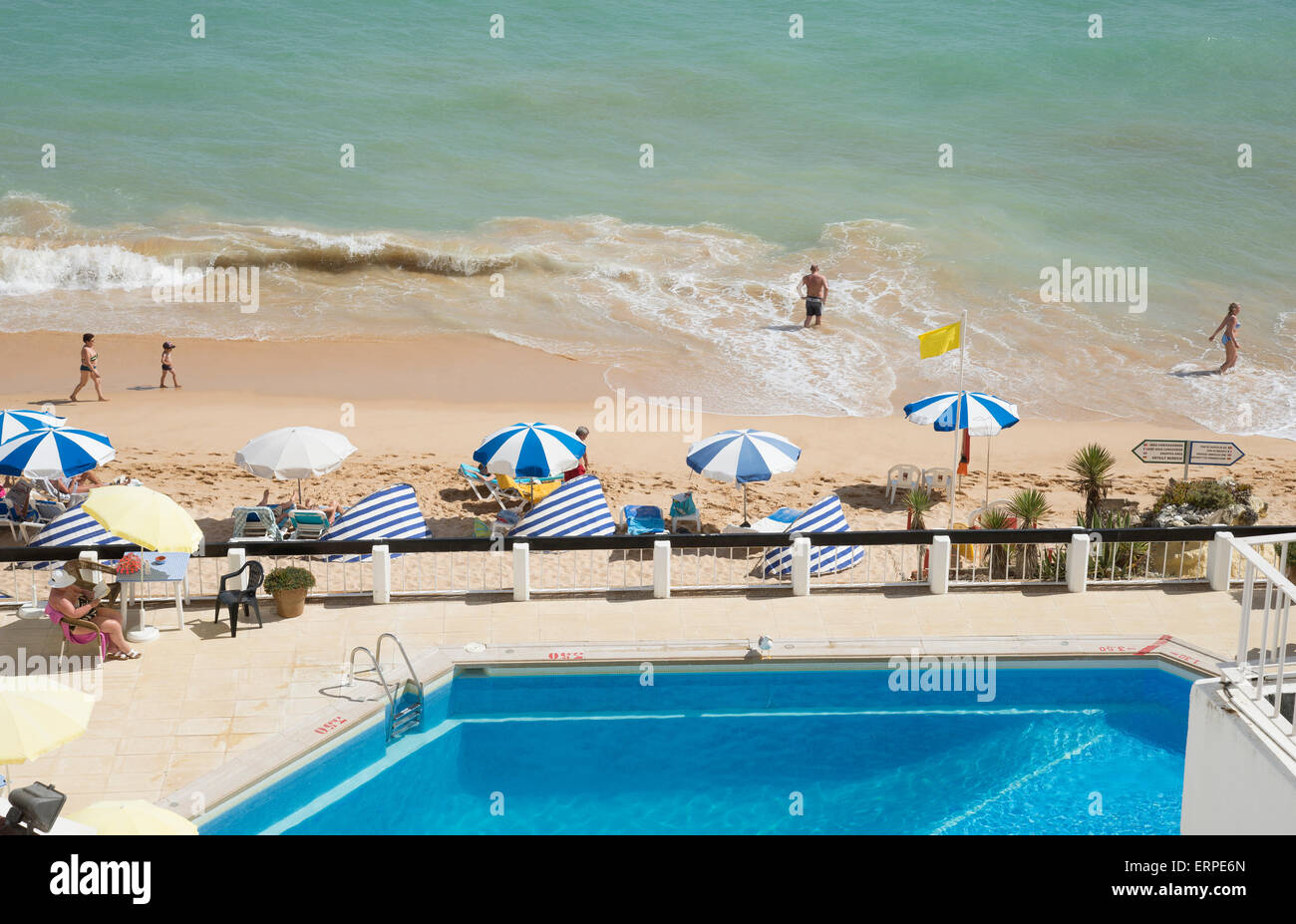 Swimming pool with a sandy beach and the sea. Algarve Portugal Stock ...
