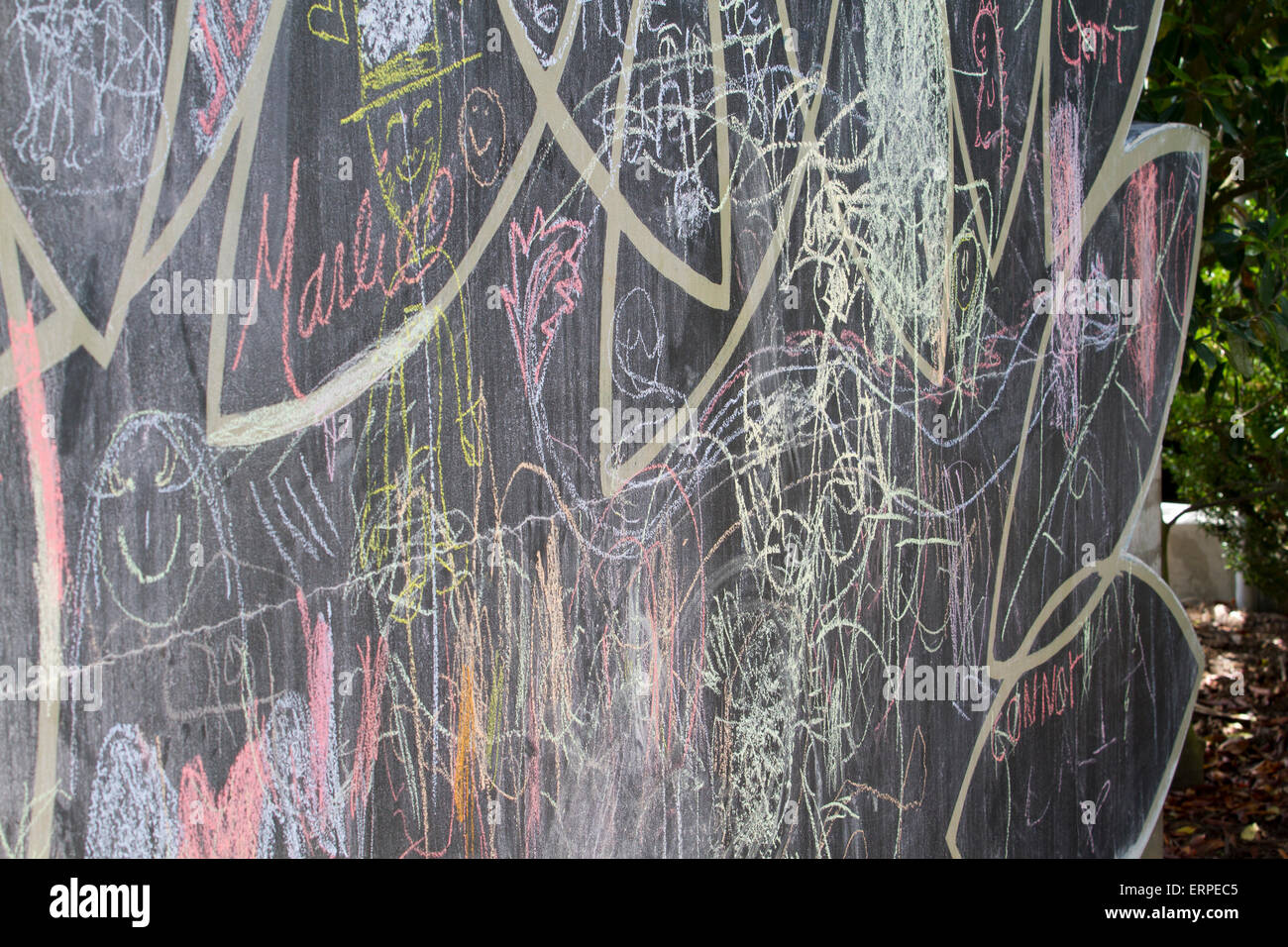 Chalkboard scribbles in many colors and forms at a local park Stock ...