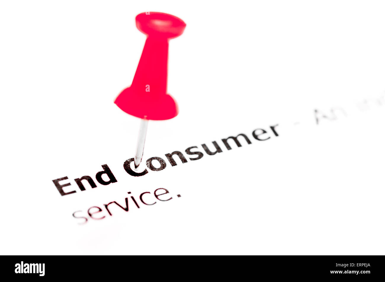 Words END CONSUMER pinned on white paper with red pushpin, available ...