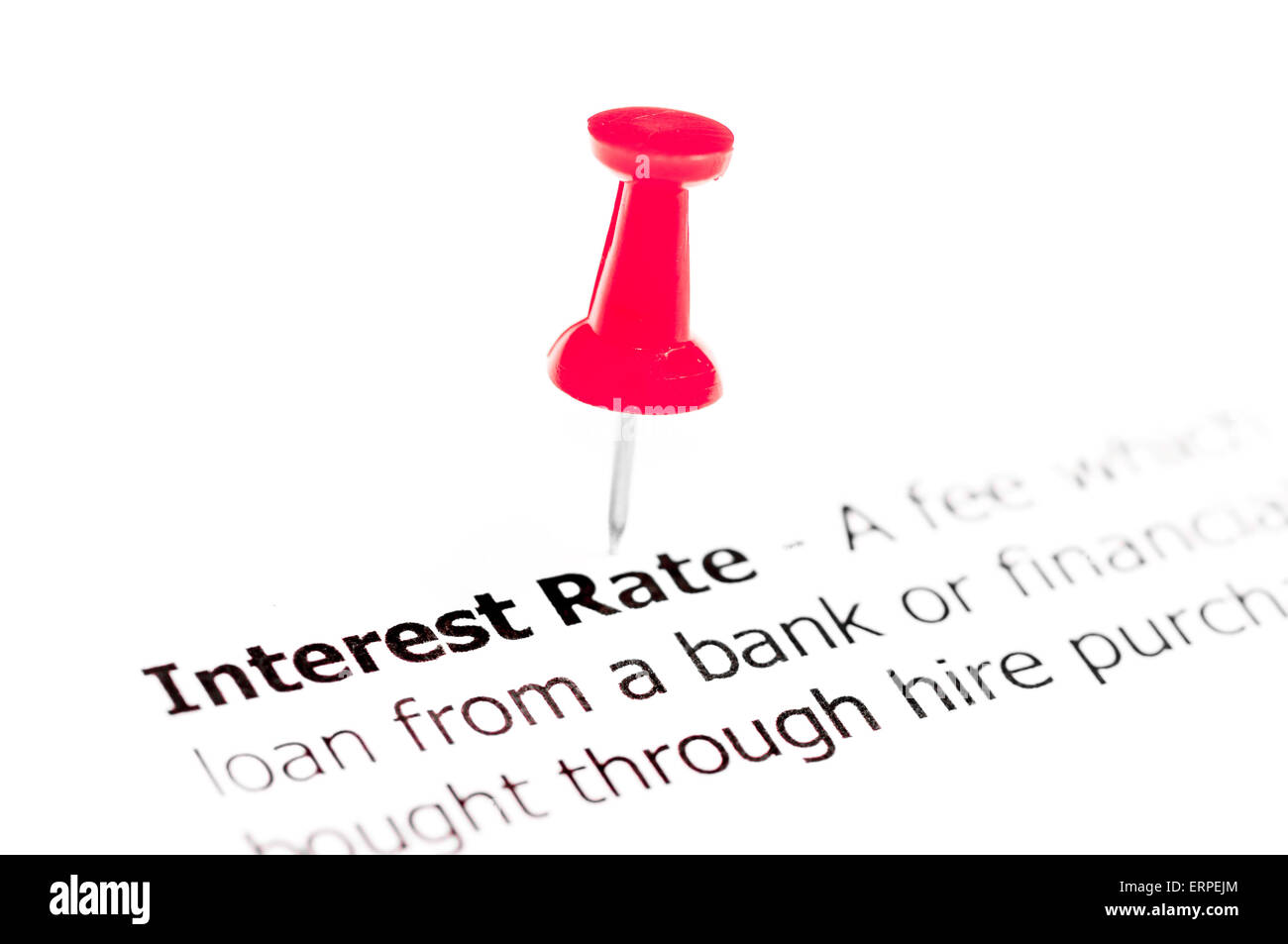 Words INTEREST RATE pinned on white paper with red pushpin, available ...