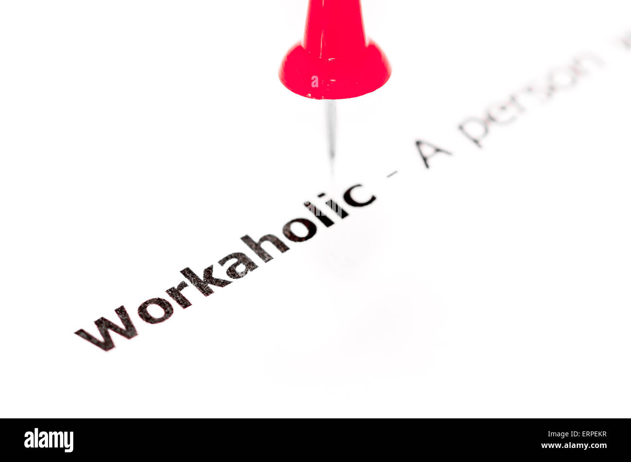 Word WORKAHOLIC pinned on white paper with red pushpin, available copy ...