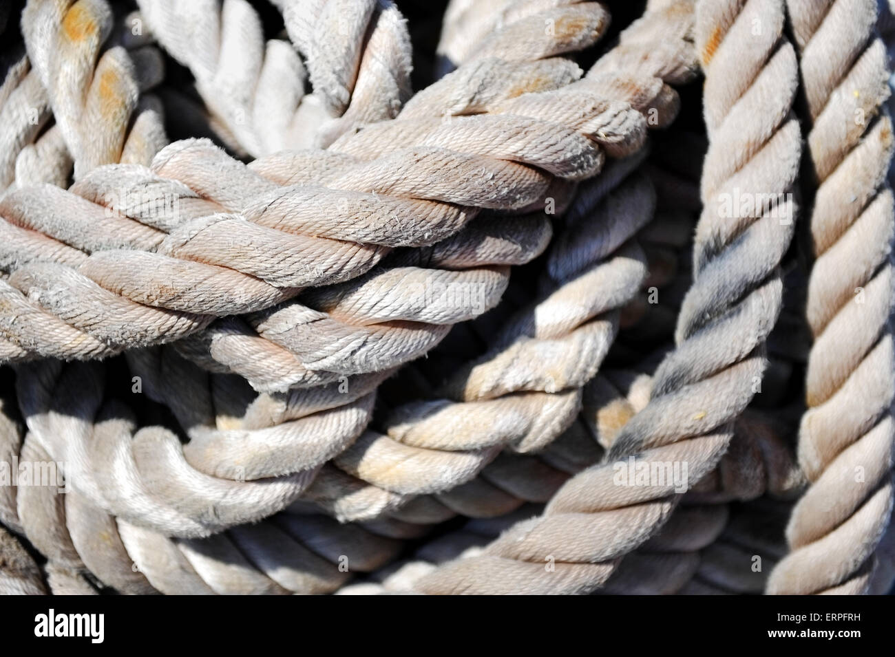 Industrial detail with a heap of old maritime sea ropes Stock Photo - Alamy