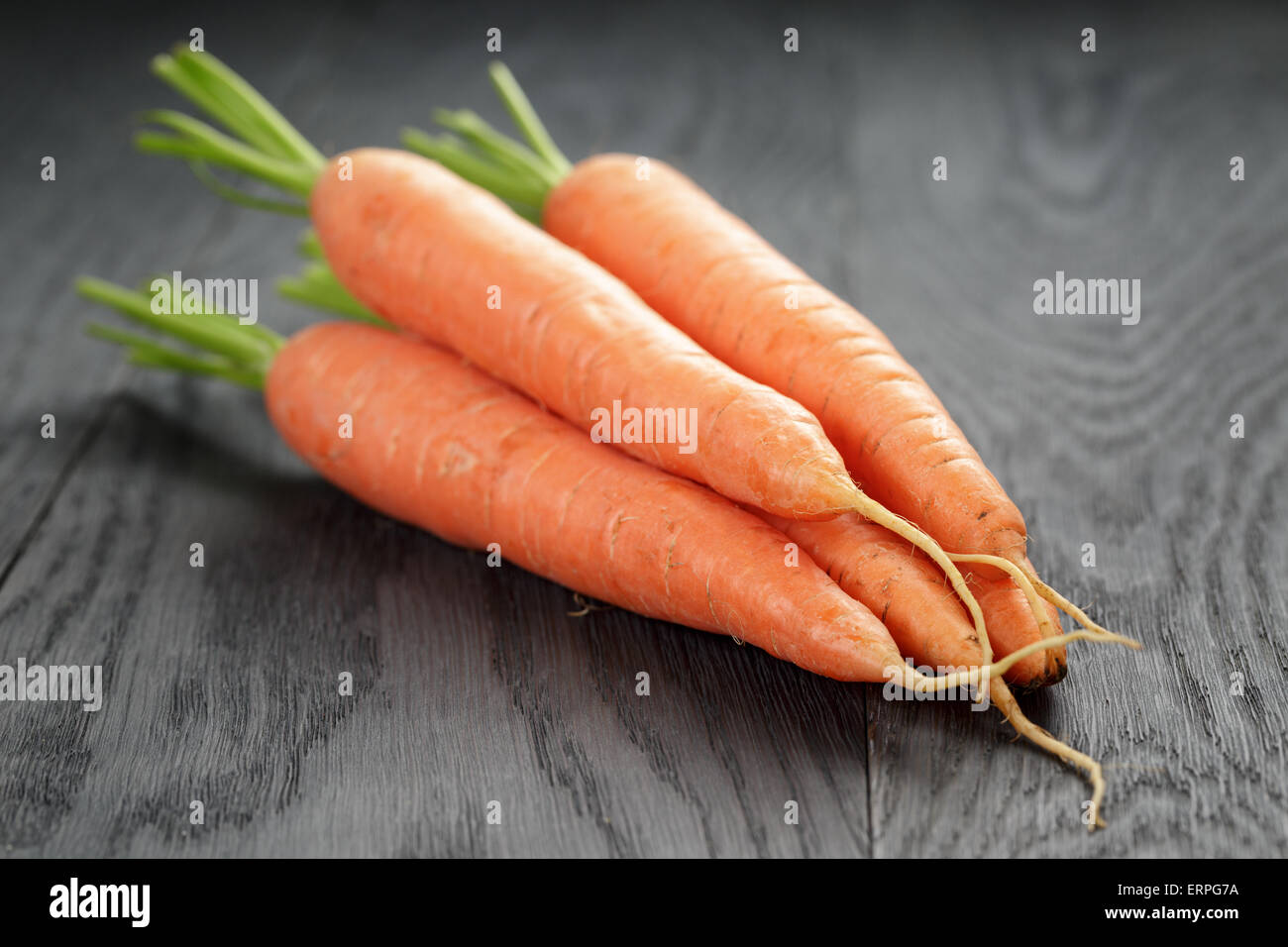 fresh carrots on old oak table Stock Photo - Alamy