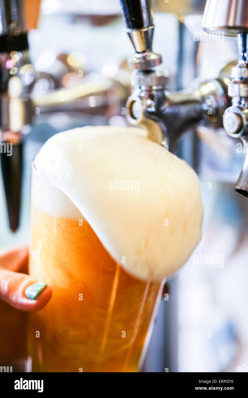 Bartender pouring draft beer in the bar Stock Photo - Alamy