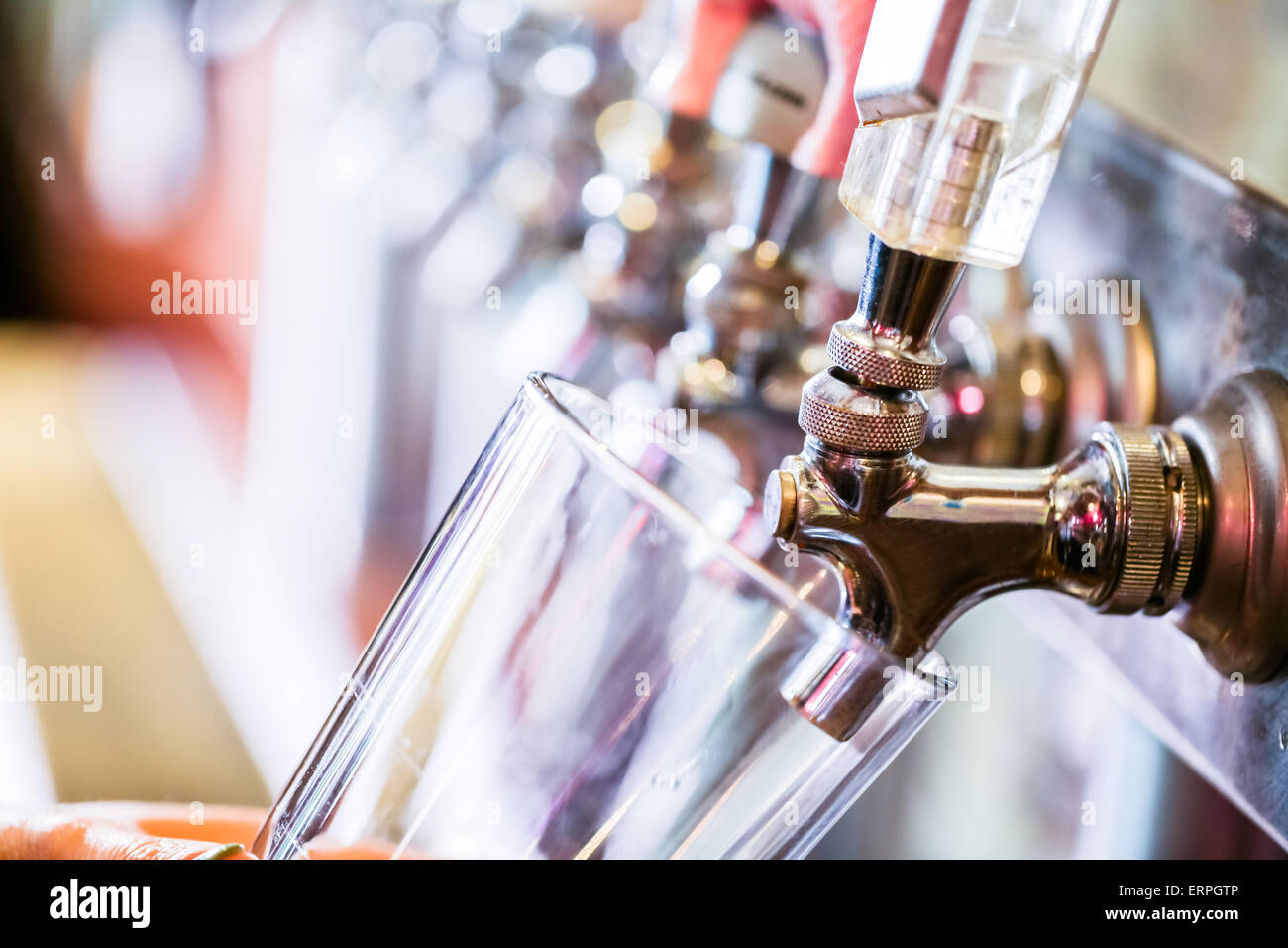 Bartender pouring draft beer in the bar Stock Photo - Alamy