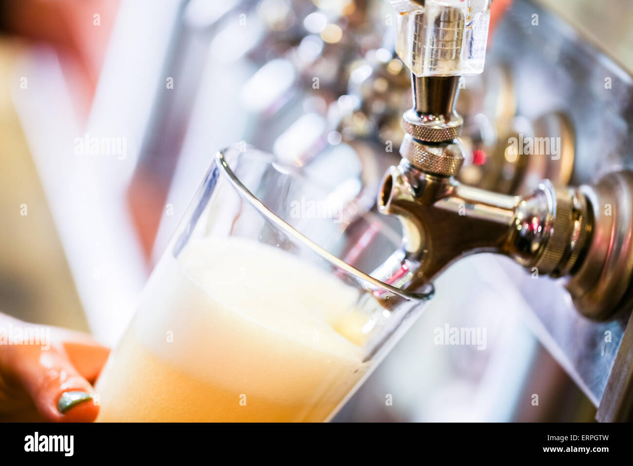 Bartender pouring draft beer in the bar Stock Photo - Alamy