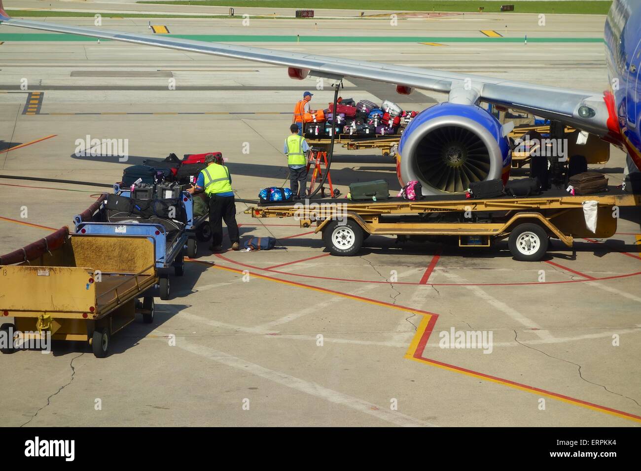 Loading baggage onto conveyor belt into airliner and refueling. Eppley ...
