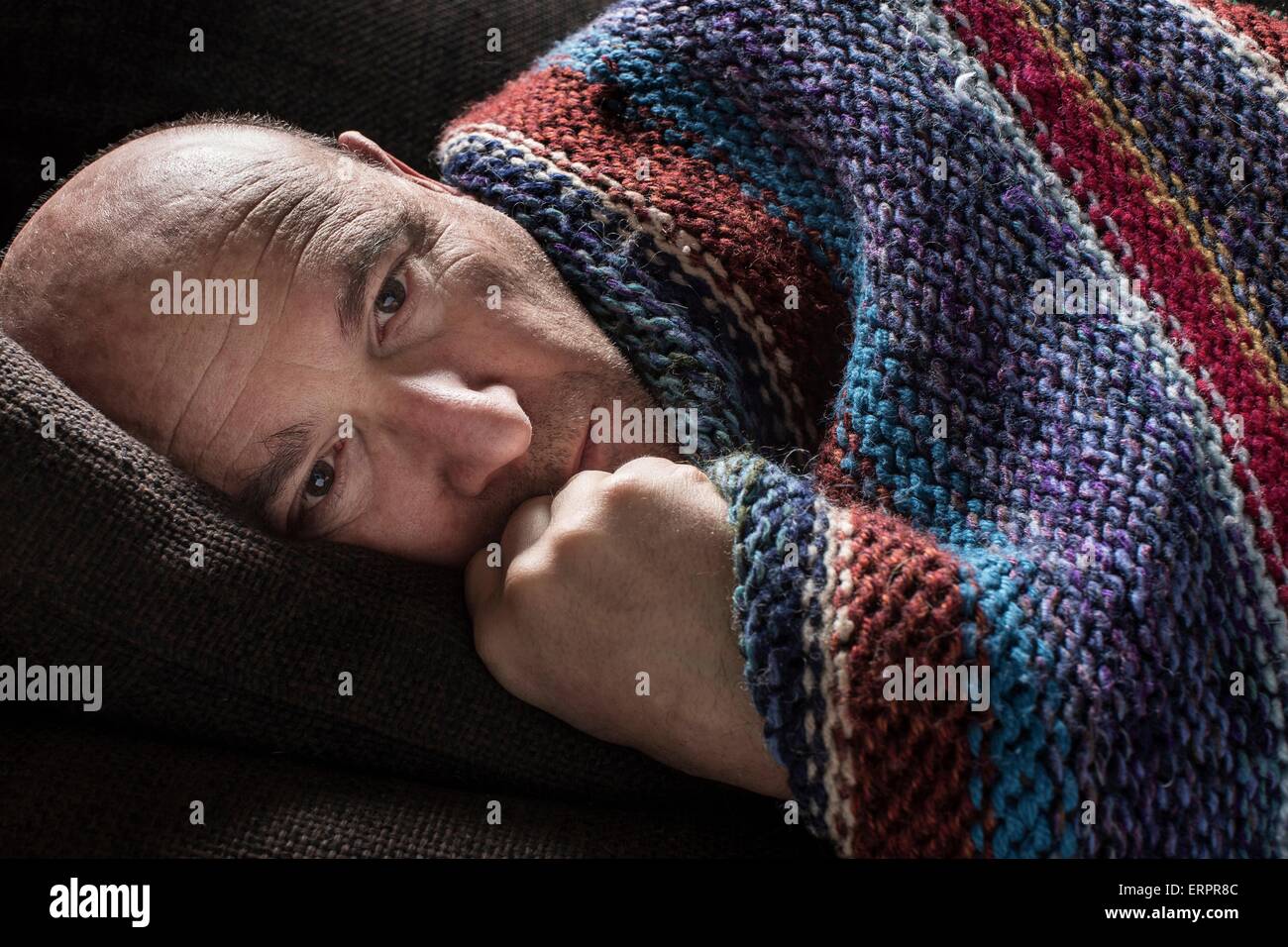 MODEL RELEASED. Mature man wrapped in a blanket Stock Photo - Alamy