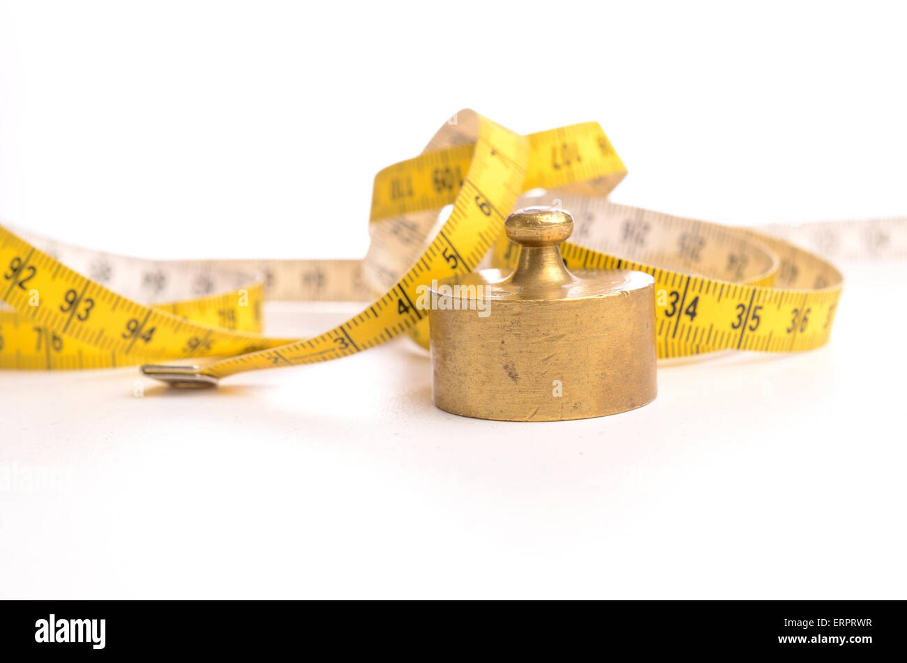 Measuring tape with an old weight on a white background Stock Photo - Alamy