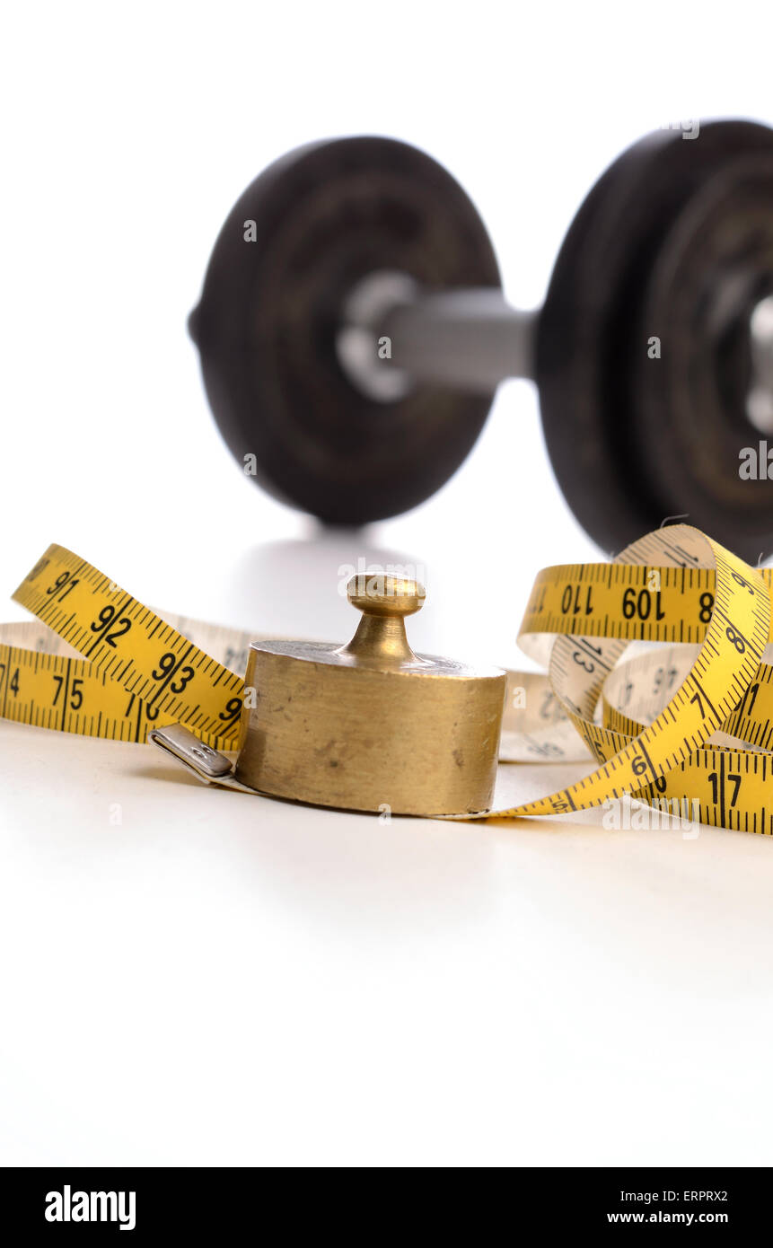 Fitness concept with a measuring tape and weights on a white background ...