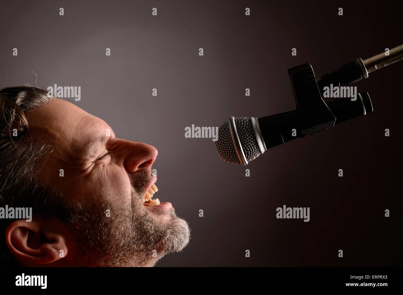 Man with microphone in a studio Stock Photo - Alamy
