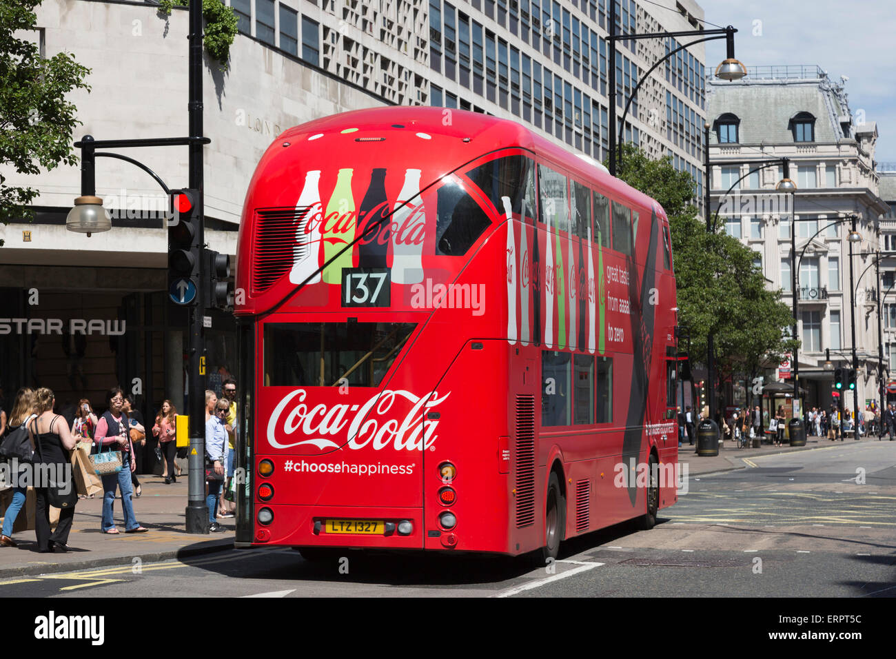 A red London Routemaster double-decker bus with Coca-Cola advertising ...