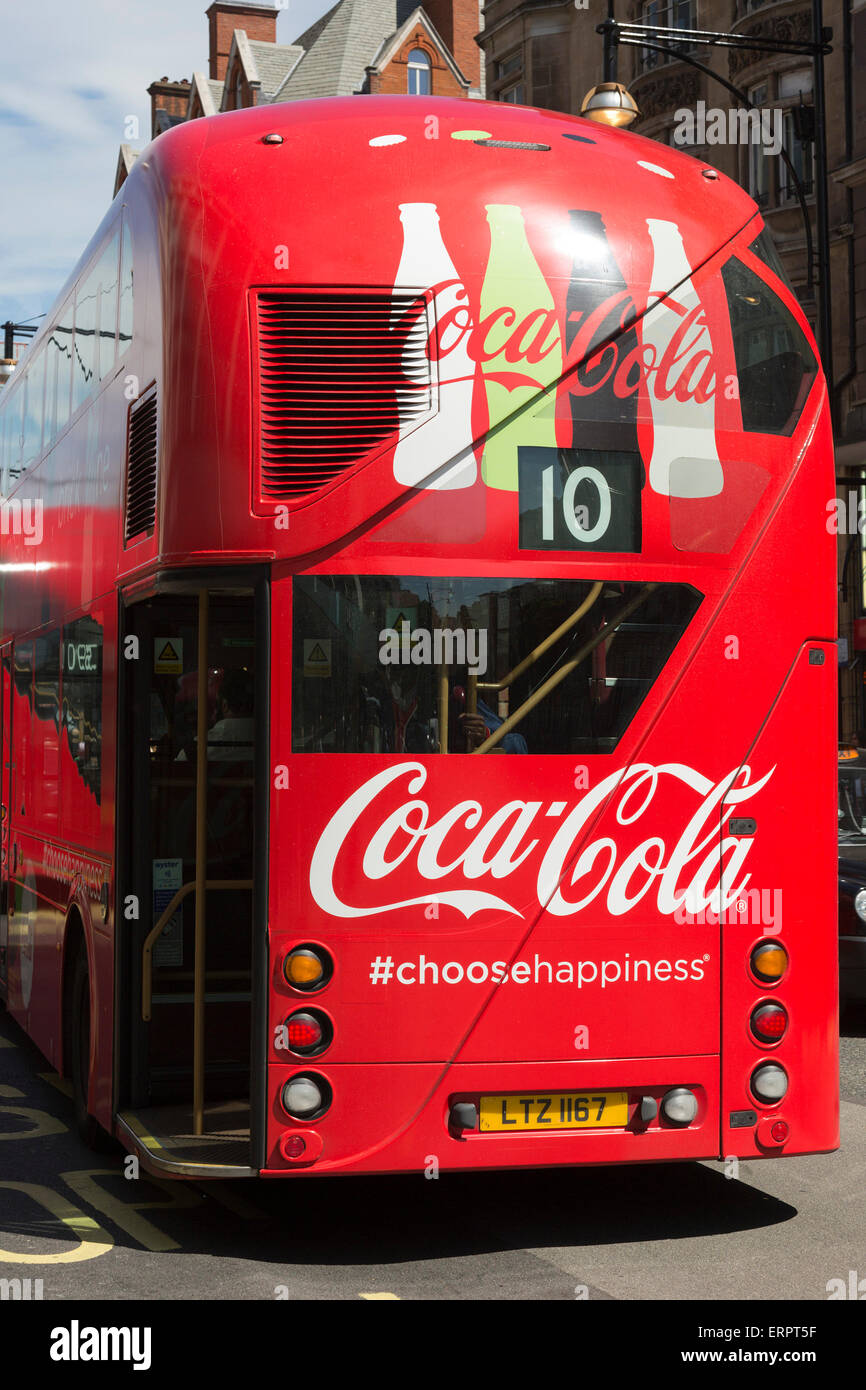 A red London Routemaster double-decker bus with Coca-Cola advertising ...