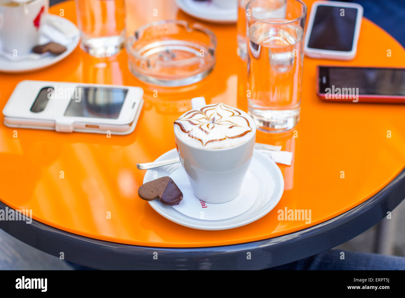 Coffee cup and mobile phone on the cafe table Stock Photo - Alamy