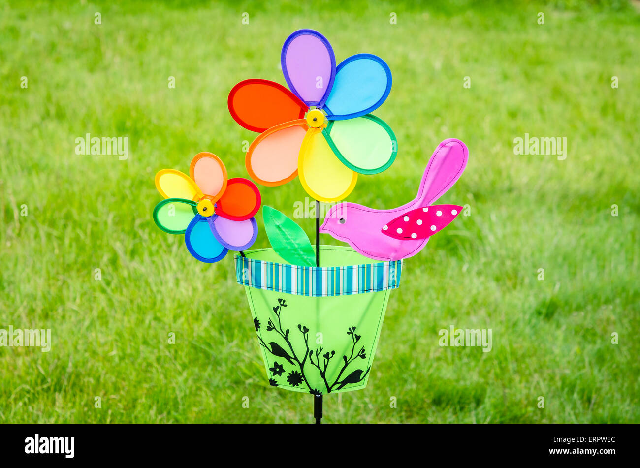 Colorful double pinwheel with bird on a green grass Stock Photo - Alamy