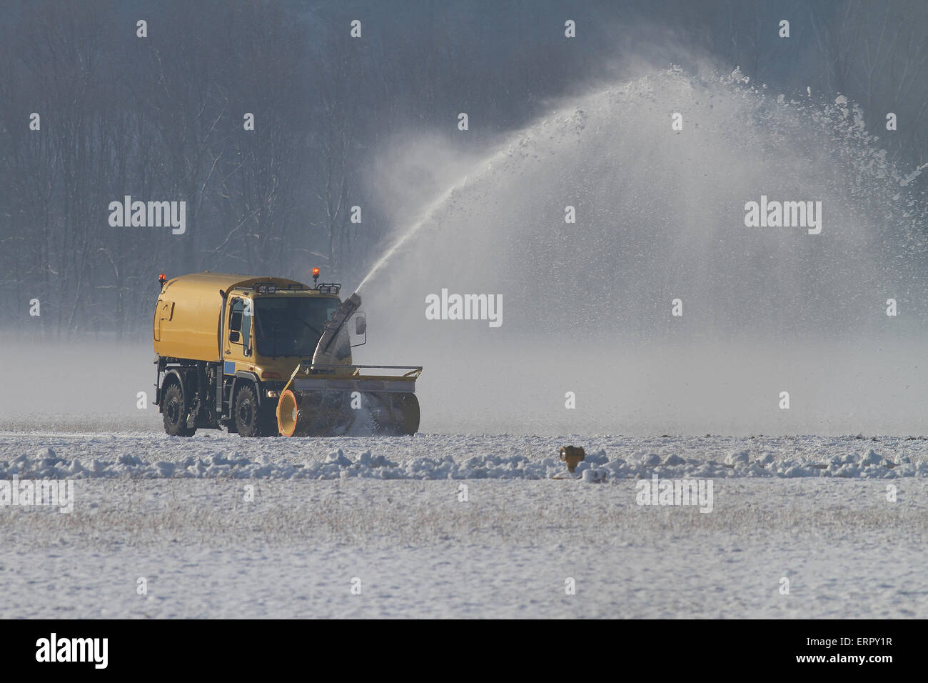 Snowplow removing snow at an airfield Stock Photo - Alamy