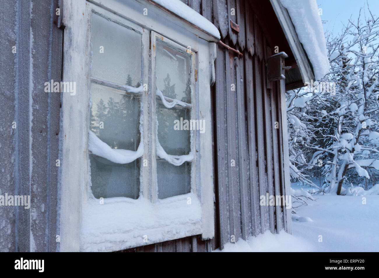 Reflection in frosty window on old house in winter and cold temperature ...