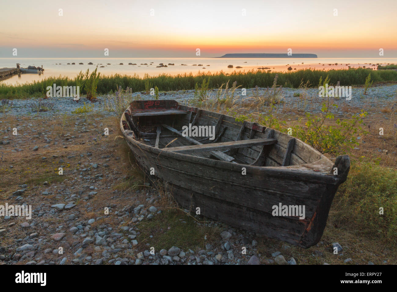 A rowing boat in sun set at the coast of Eksta in Gotland, Sweden Stock ...