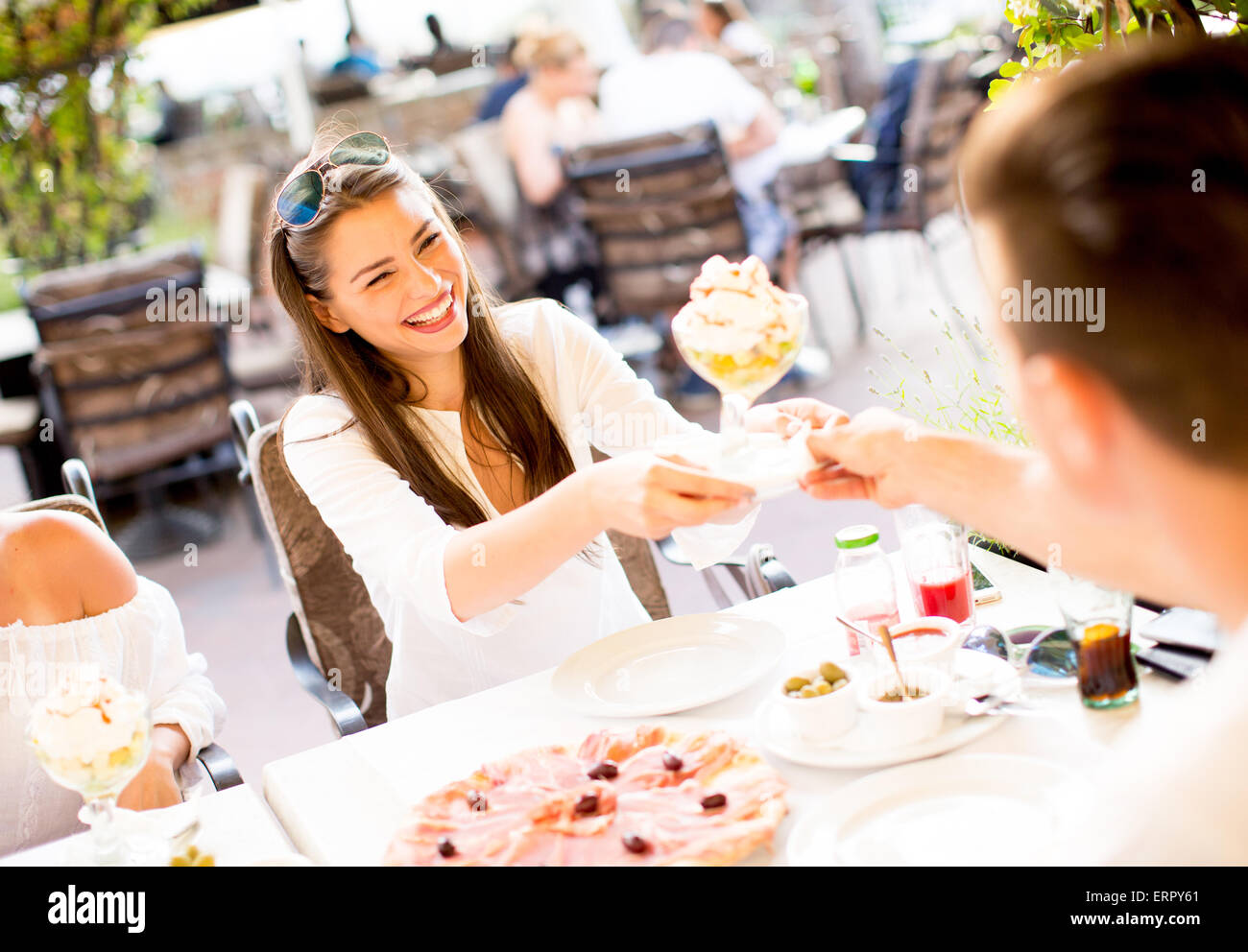 Young people by the table Stock Photo - Alamy