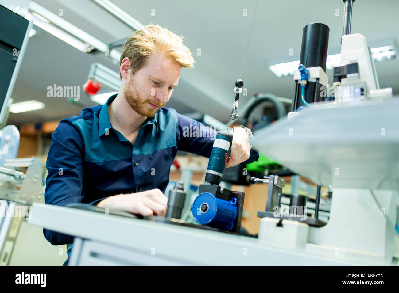 Young man in electronics workshop Stock Photo - Alamy
