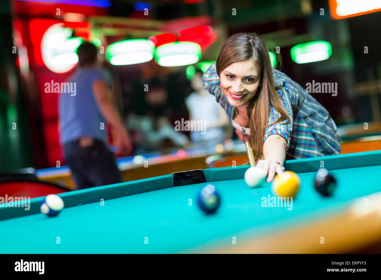 Young woman playing pool Stock Photo - Alamy