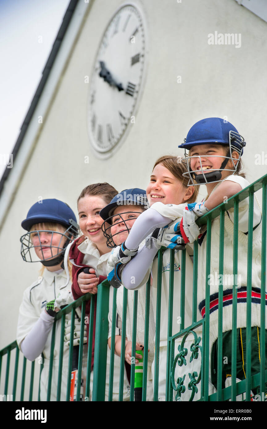 Girls watch their teams batting performance from the pavilion balcony ...
