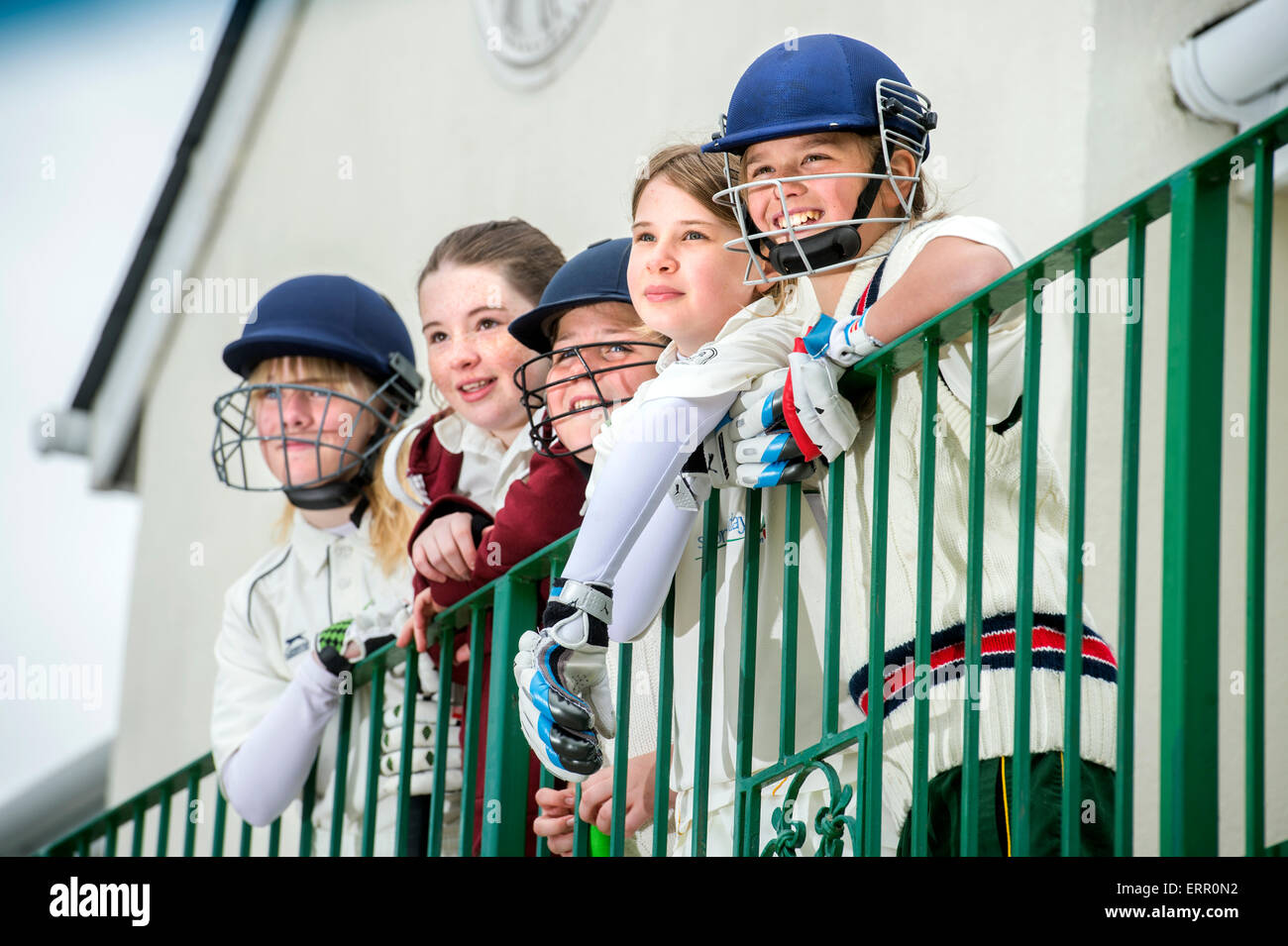 Girls watch their teams batting performance from the pavilion balcony ...