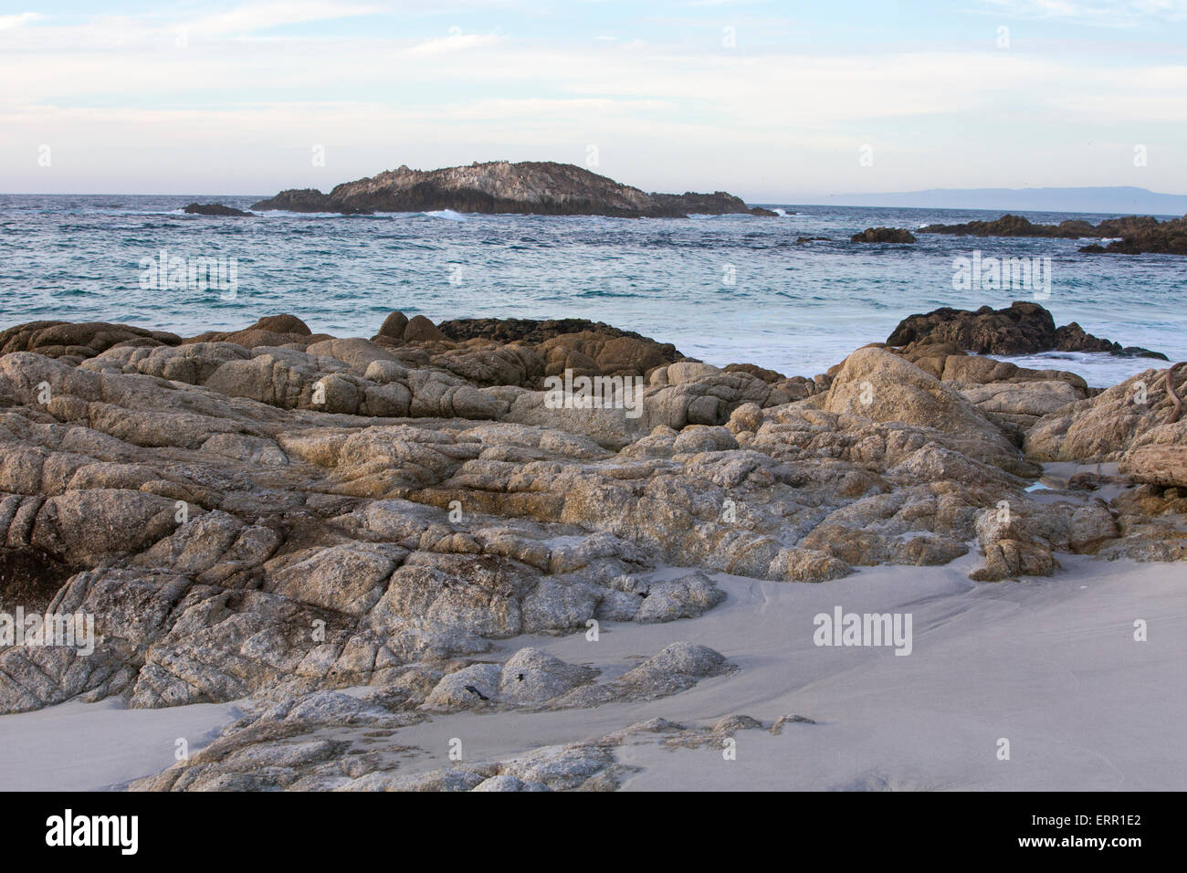 beautiful sand beach with rocks and blue waves Stock Photo - Alamy