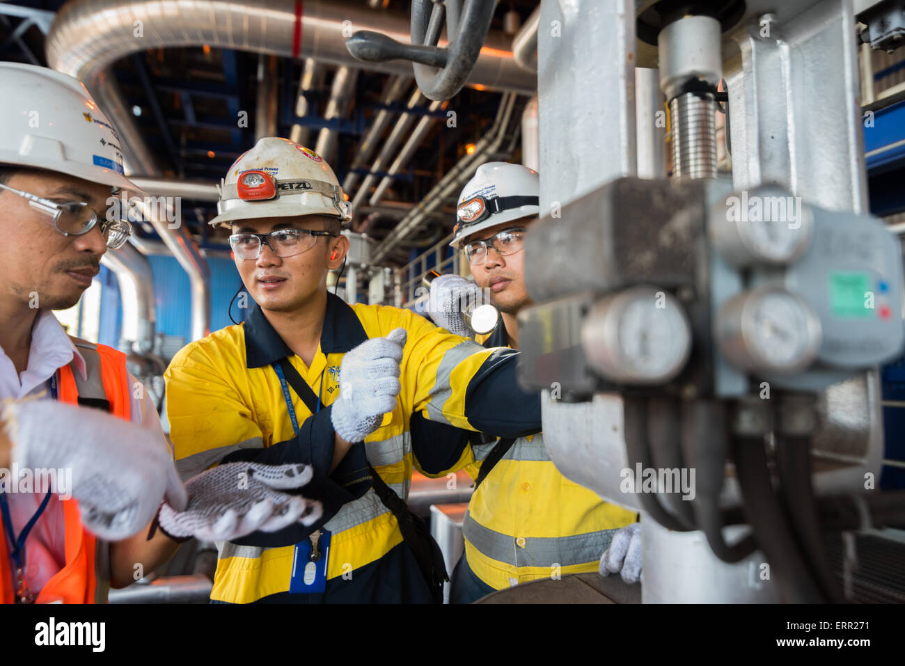 An instructor is giving an explanation to young technicians during a ...