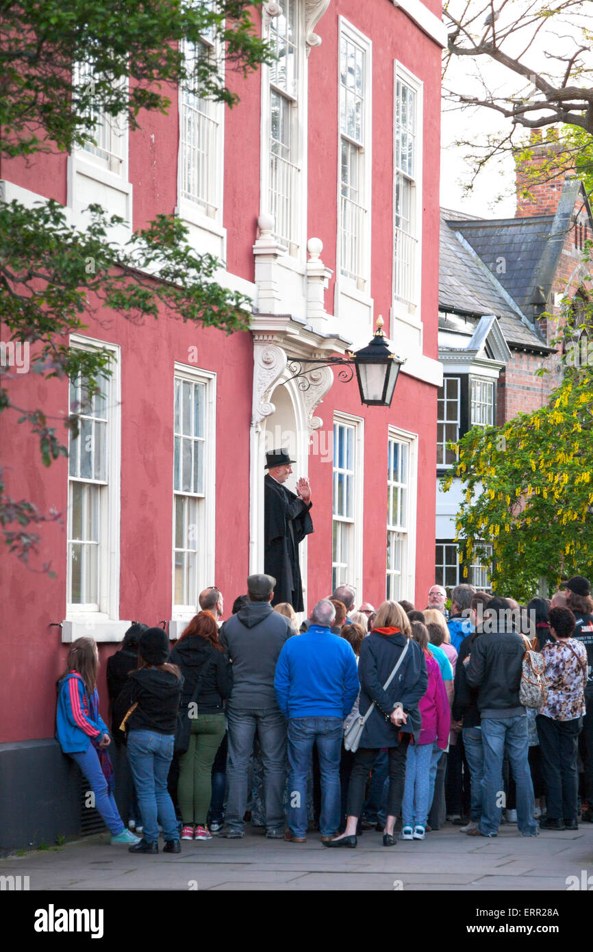A tour guide showing around a group of visitors at the York Ghost Tour ...