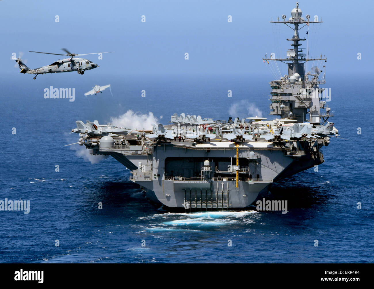 US Navy MH-60S Sea Hawk helicopter performs plane guard operations near ...