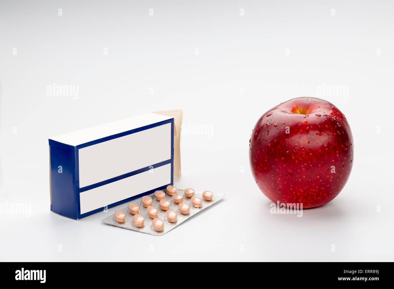 Pill box and red apple on white background Stock Photo - Alamy