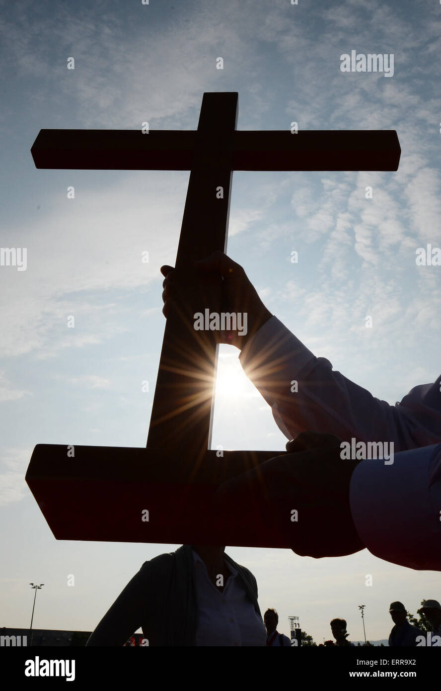 A pastor prepares a cross on an altar at the 2015 Evangelical Church ...