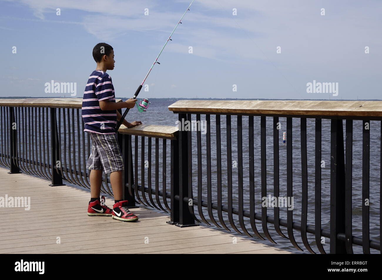 Young fisherman tries his luck at the fishing pier, Keyport, New Jersey ...