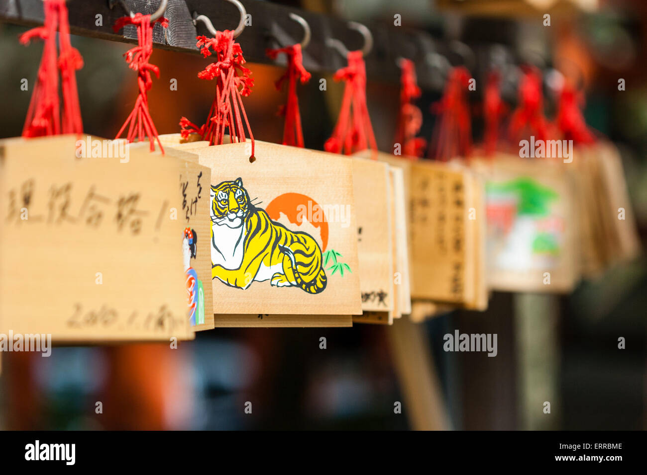 Ema boards, prayer or wishing tablets, hanging from vermilion cords in ...