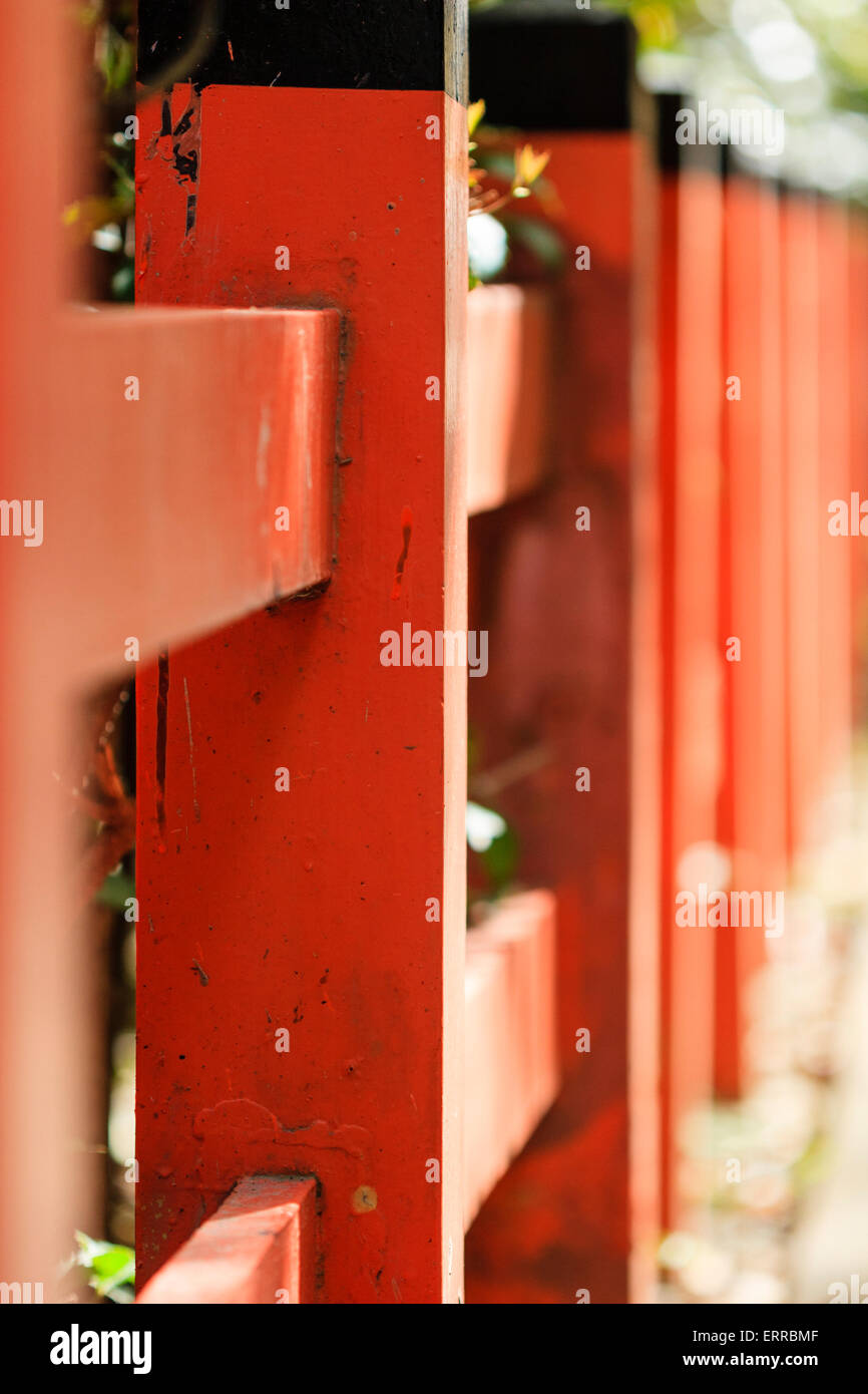 Compressed perspective view along a row of vermilion black topped fence ...
