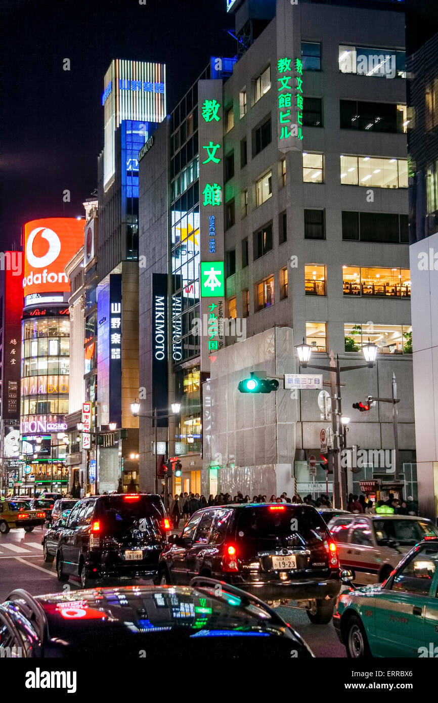 The Ginza at night. View along traffic filled street with the Mikimoto ...