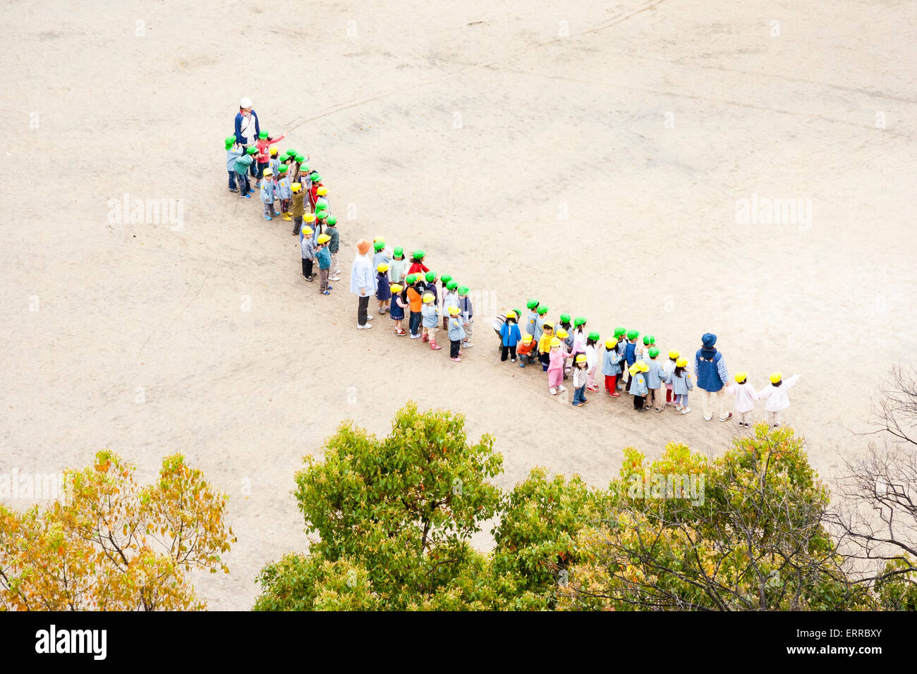 Japan. Aerial view of 'train' of infant school children being lead ...
