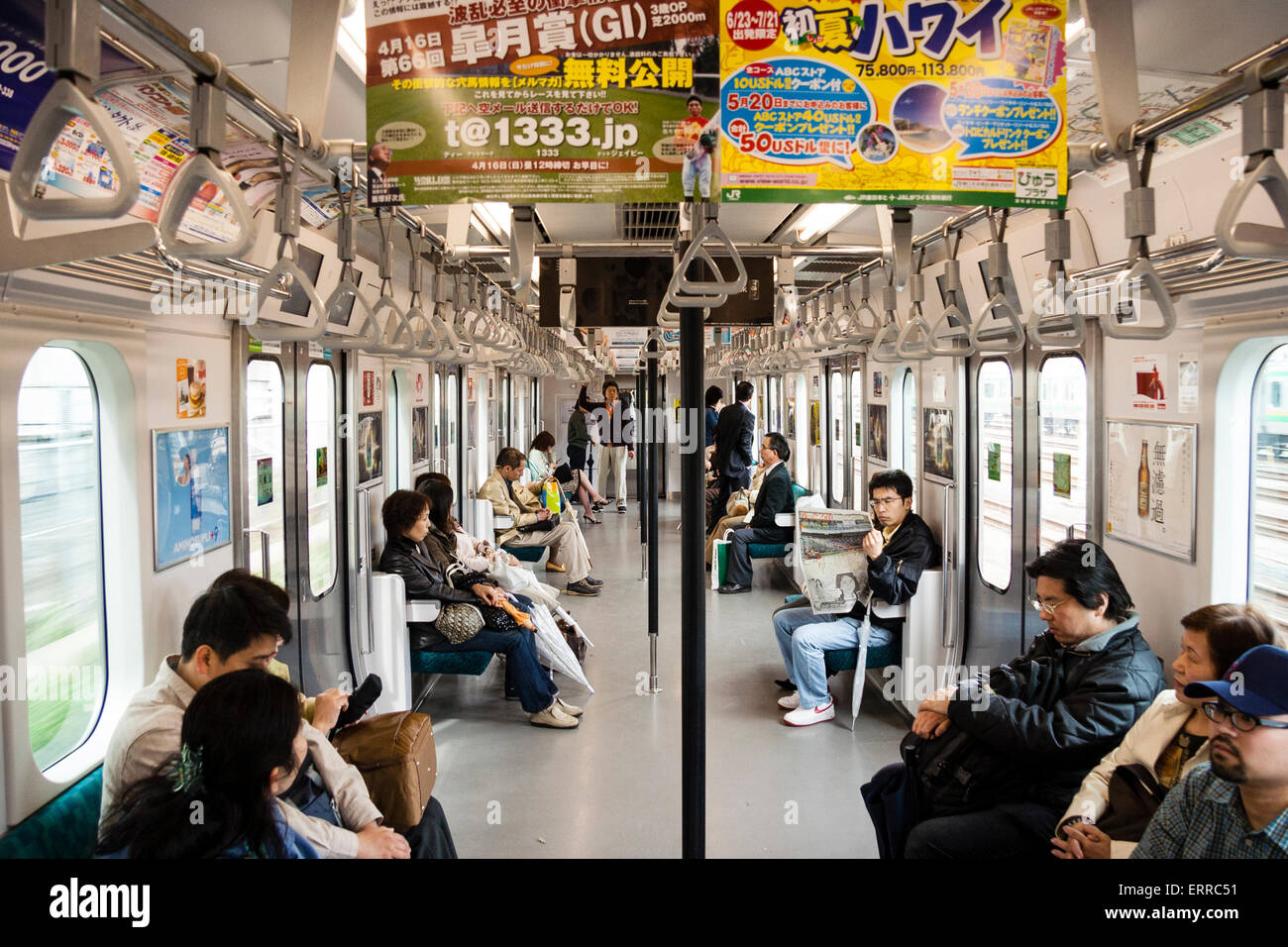 Interior of Japanese commuter railway carriage with passengers sitting ...