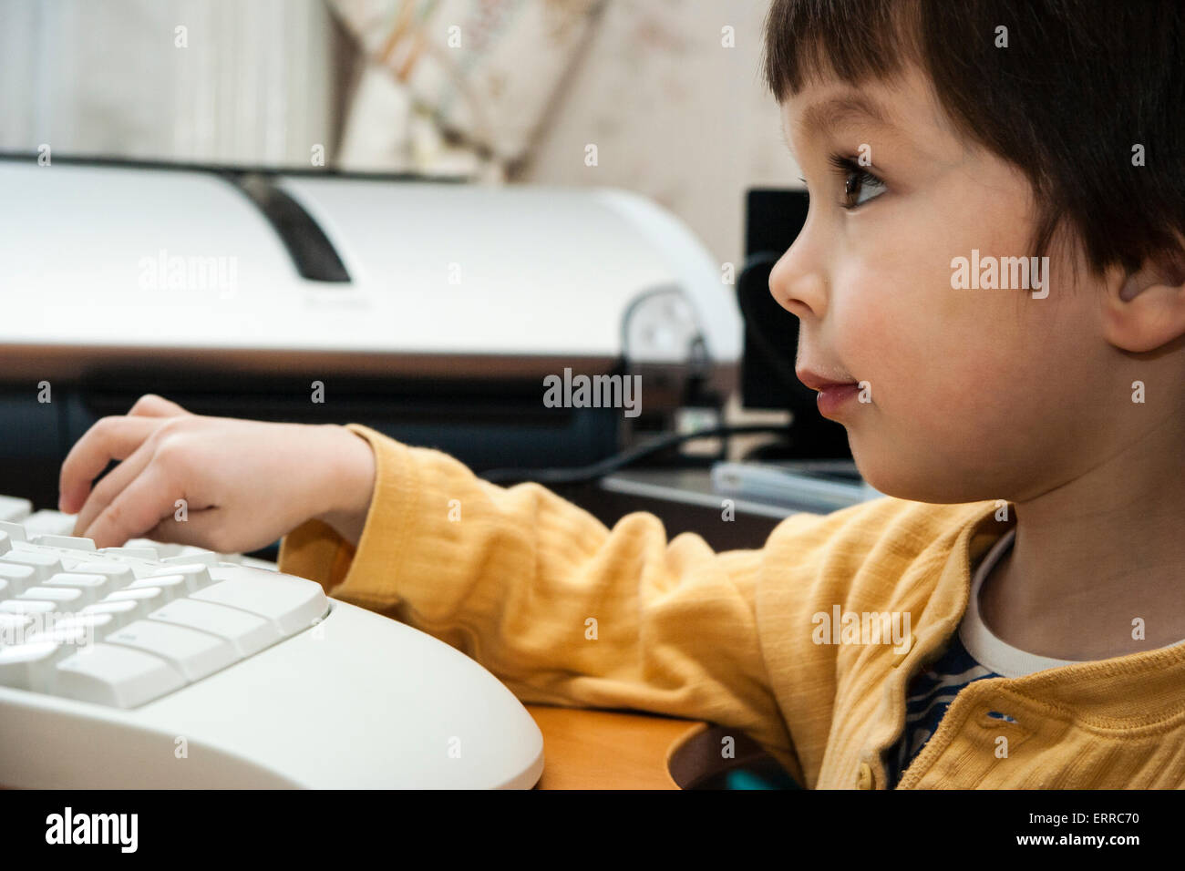 Close up side view of face of a Caucasian child, boy, 4-5 year old, at ...