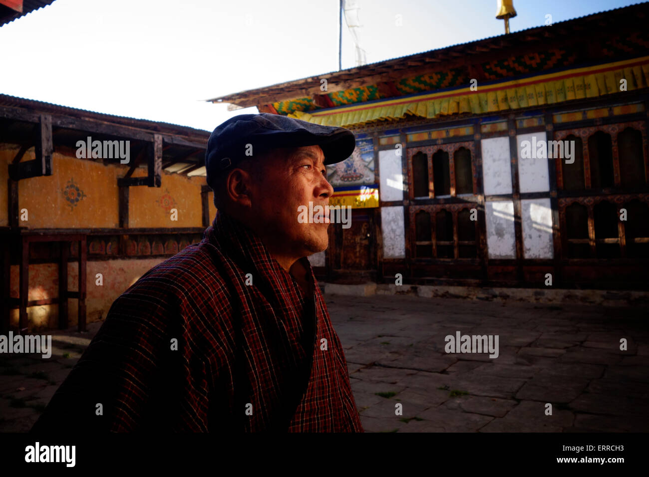 A Buddhist devotee at the courtyard of Tamshing Lakhang temple formally ...