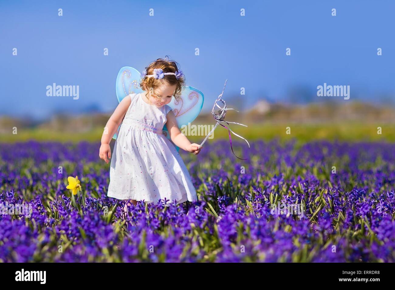 Portrait of an adorable toddler girl in a magic fairy costume and ...