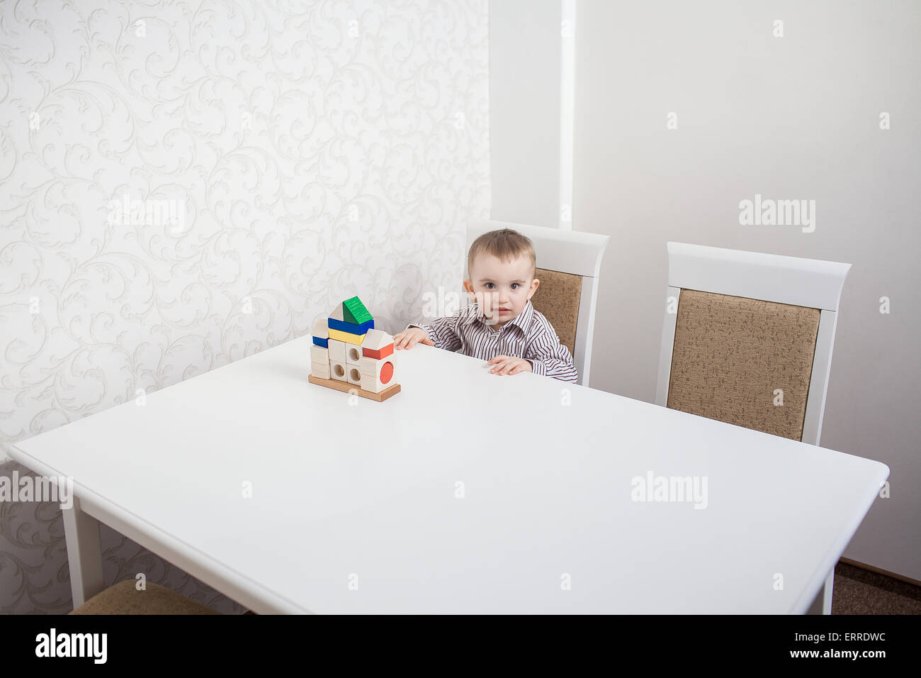 Boy playing with blocks at table hi-res stock photography and images ...