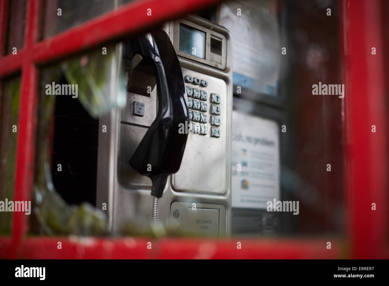 Through the broken window of a red telephone box Stock Photo - Alamy