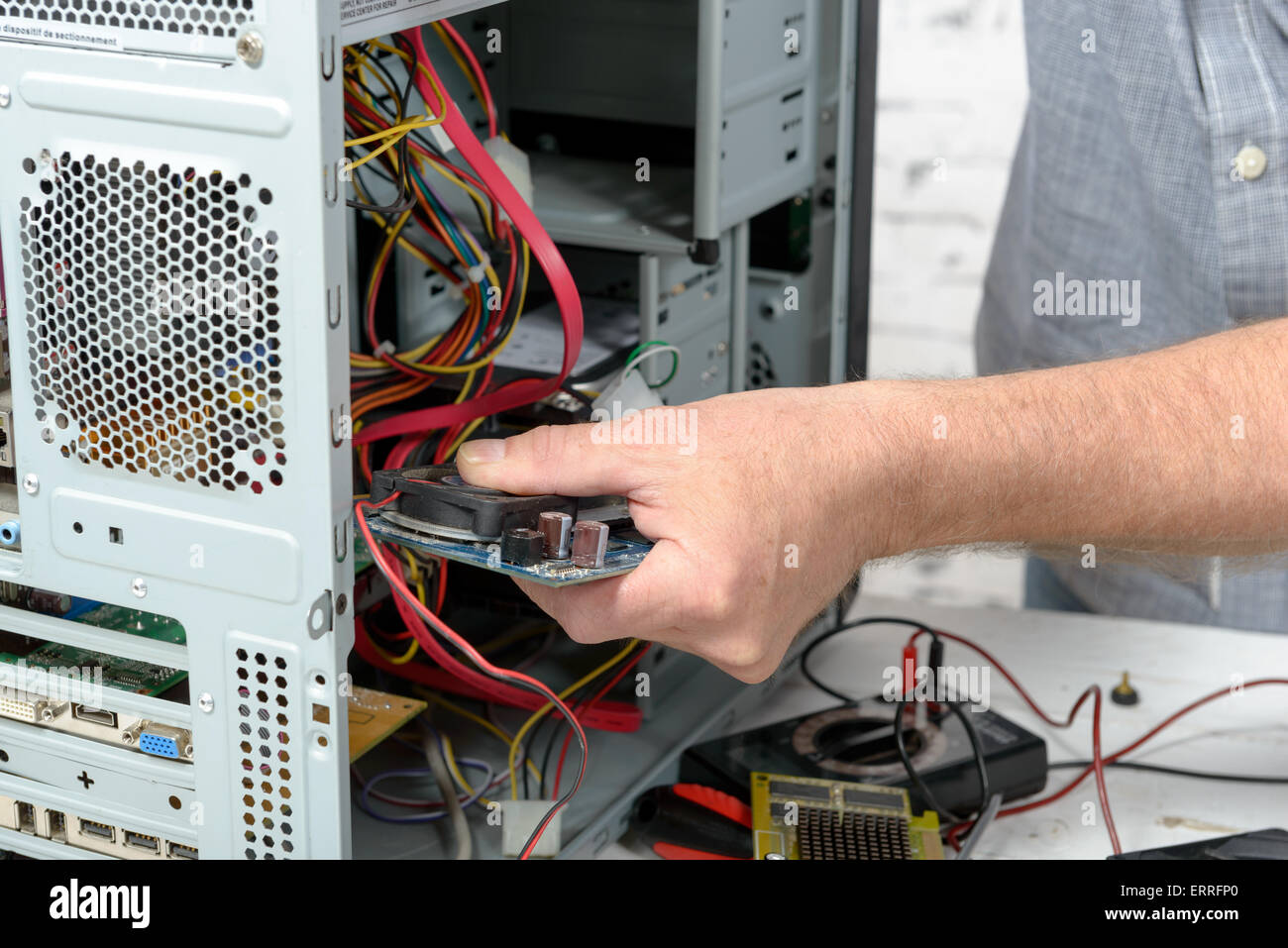 a technician repairing a computer with different tools Stock Photo - Alamy