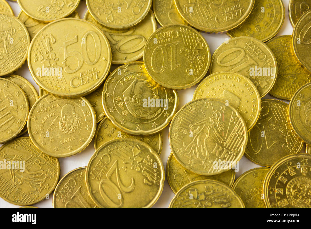 Golden European coins in white background Stock Photo - Alamy